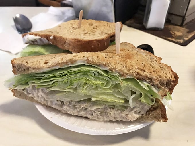 Layer upon layer of tuna goodness with crisp lettuce. This isn't just a sandwich; it's architecture you can eat.