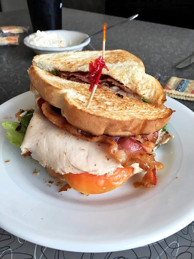 The Summit Club sandwich: architectural marvel, flavor powerhouse, and the reason napkins were invented. Worth every delicious crumb.