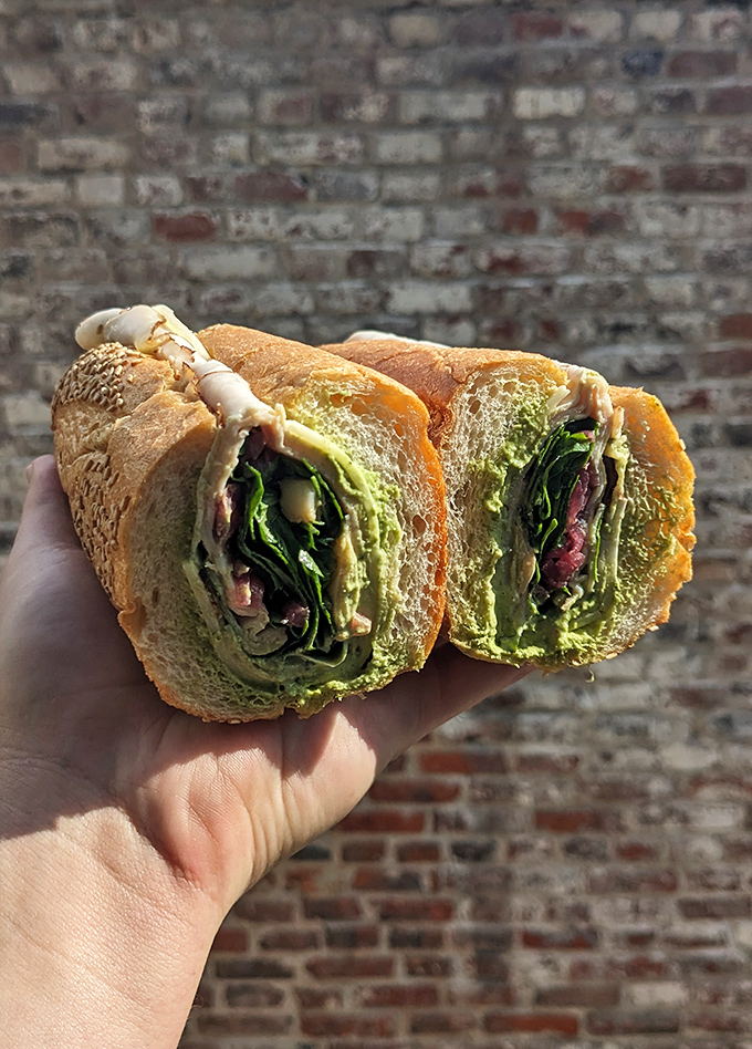 Behold the legendary turkey pesto – where vibrant green meets tender meat in a sandwich so good it's sparked pilgrimages across the city.