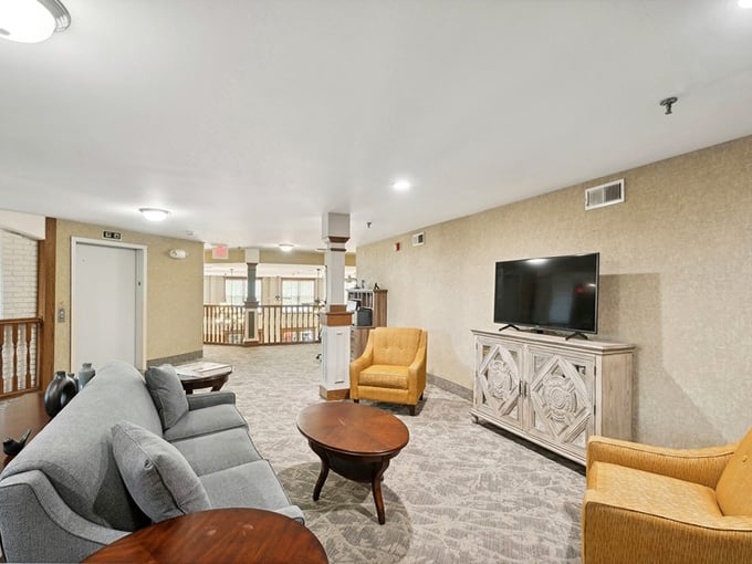 The community lounge says "come stay awhile" with comfortable seating that's stylish enough for visitors but supportive enough for residents. Remote control battles still occur daily. 