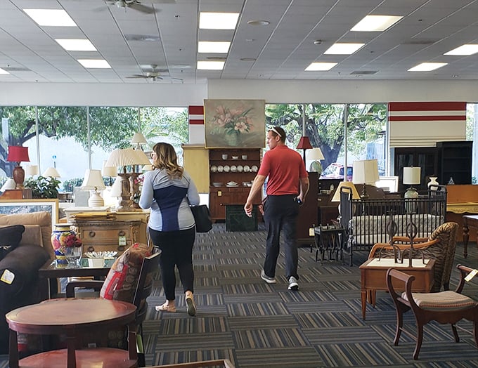 Shoppers on the hunt navigate furniture islands like explorers charting new territory – each turn revealing potential domestic treasures.