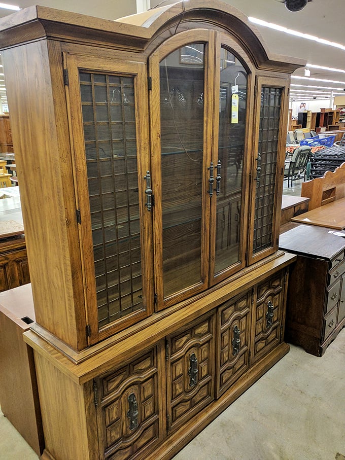 This majestic china cabinet isn't just furniture; it's a time machine to Sunday dinners at grandma's house, complete with crystal and china.
