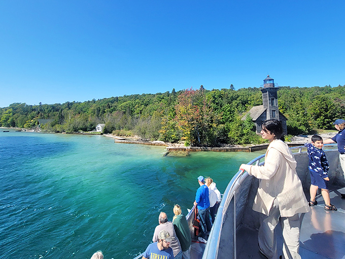 Wide-eyed visitors lean over the rail, soaking in Pictured Rocks’ turquoise waters and storybook shoreline—proof that sightseeing here is anything but ordinary.