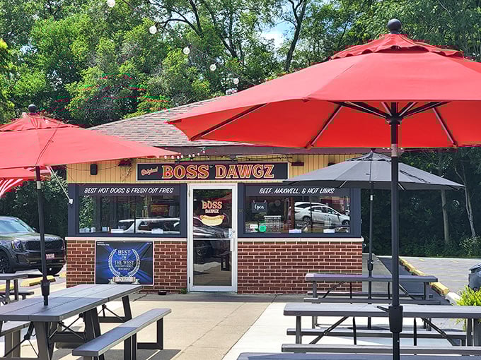 Modern comfort meets classic flavors under those cheerful red umbrellas—outdoor dining never looked so inviting and delicious.