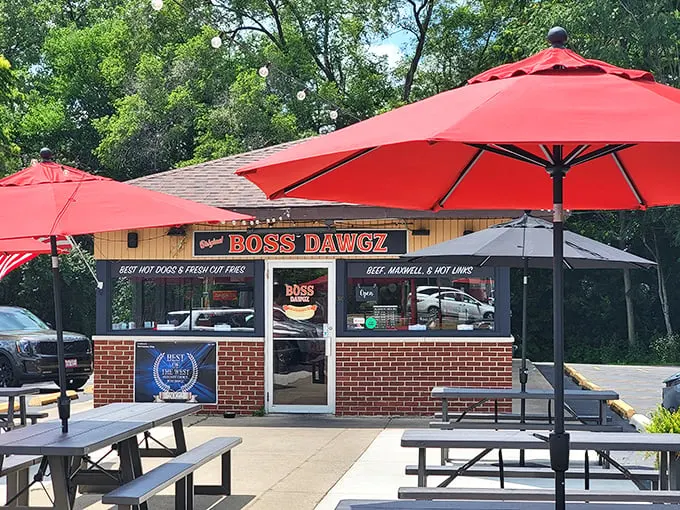 Modern comfort meets classic flavors under those cheerful red umbrellas—outdoor dining never looked so inviting and delicious.