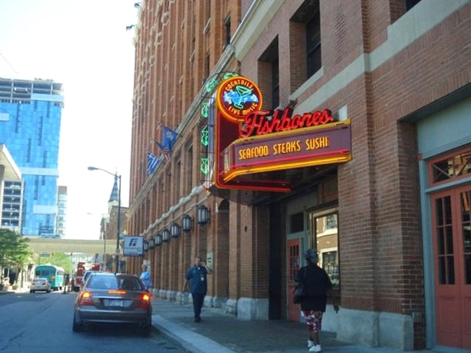 Fishbones lights up Greektown with neon promise. That sassy little crab on the sign knows exactly what you're in for—a seafood party!