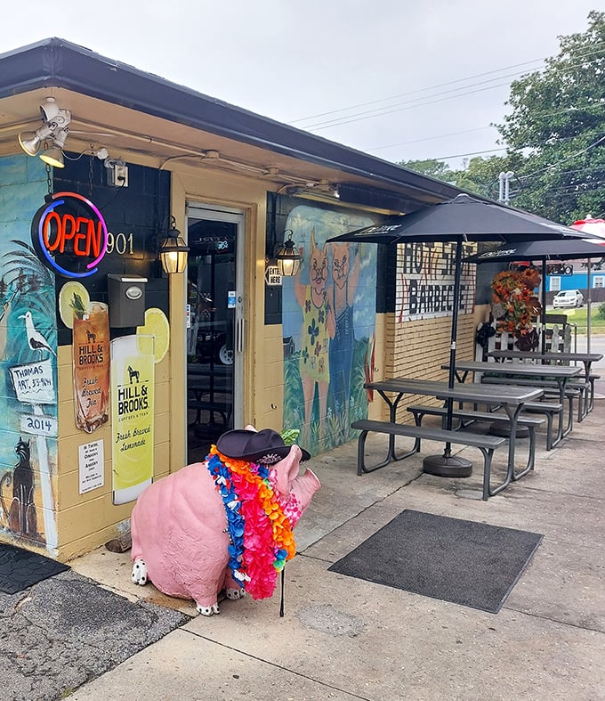The pink pig greeter wears a lei—a whimsical welcome to a serious flavor party happening inside.