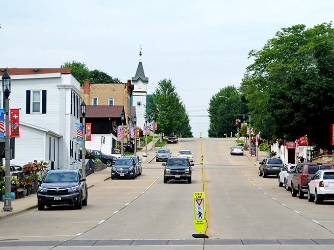 New Glarus streets climb toward that distinctive church steeple, a Swiss-inspired beacon in America's heartland below.