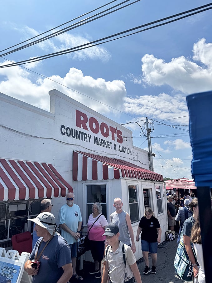 Tuesday traditions at Roots Market! Shoppers and sellers gather under this white building's red trim for Lancaster County's best bargains.