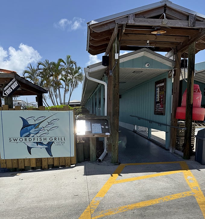 Swordfish Grill's entrance is like the gateway to Old Florida—weathered wood, fishing village charm, and the promise of something delicious waiting inside.
