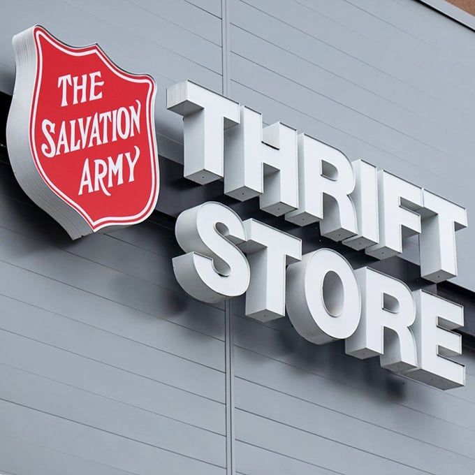 The iconic red shield of Salvation Army Thrift Store signals serious bargain hunting territory ahead.