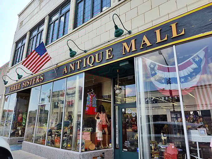 Three Sisters Antique Mall stands proud with its American flags and golden lettering, like Main Street USA frozen in time.