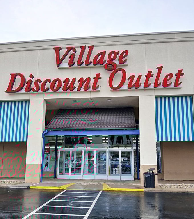Village Discount Outlet's bold red lettering promises what lies within – a village-sized collection of bargains waiting to be discovered.