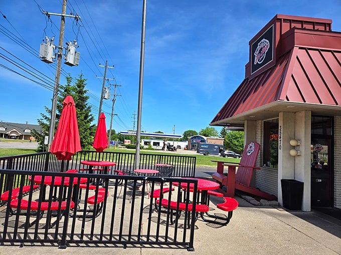 Red tables dot the patio at Anchor Bay Pit Stop Diner, perfect for enjoying their famous breakfast while soaking up Michigan sunshine.