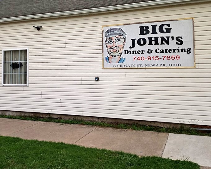 The hand-painted sign says it all—Big John's is about personality, not pretension. That motorcycle knows where the good food is!