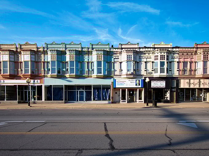 The vibrant storefronts of downtown Iola create a rainbow effect against the blue Kansas sky—affordable small-town living with unexpected visual charm.