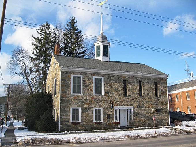 Milford’s historic stone building stands strong through the seasons, its weathered walls echoing stories of the past.