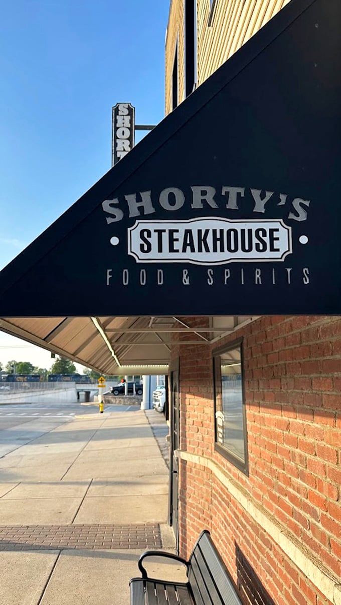 That traditional steakhouse awning signals serious business – the kind where every cut of meat gets proper respect.