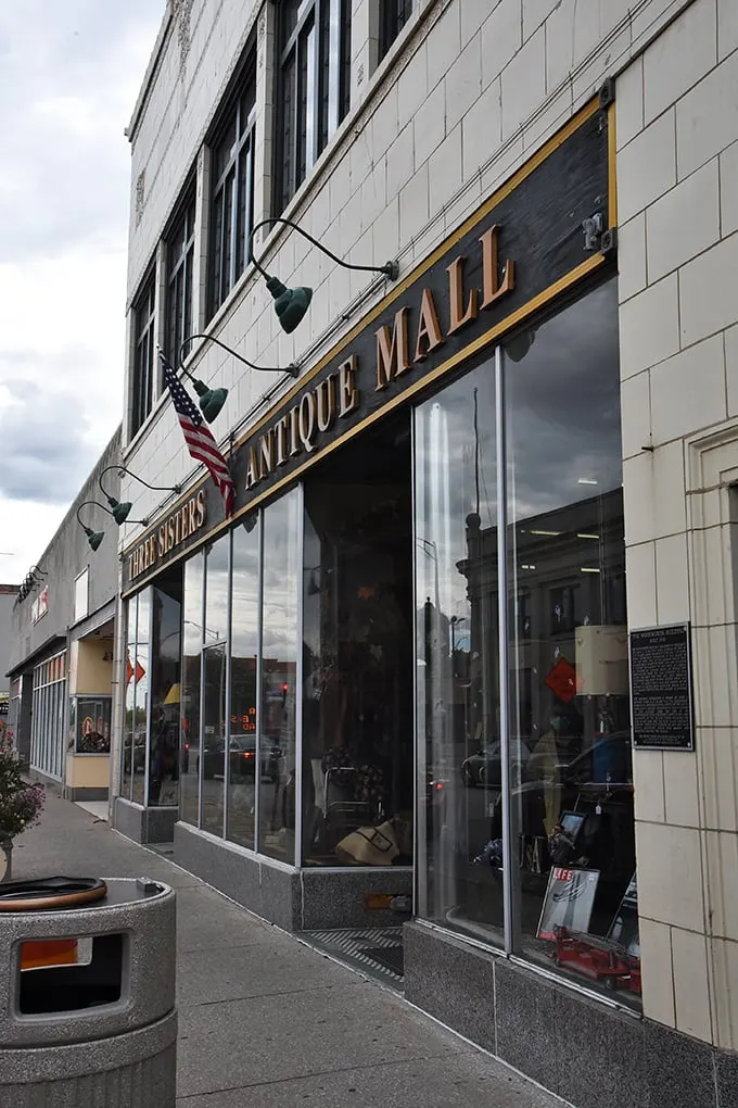 Those green lamps illuminate more than just a sign—they light the way to multiple floors of vintage wonderland.
