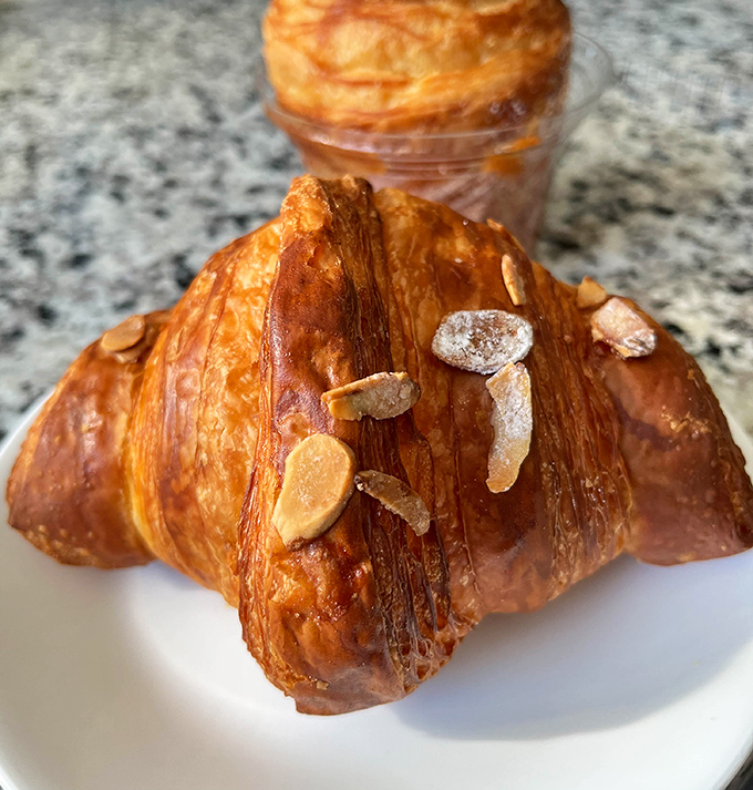 This almond croissant isn't just breakfast—it's a masterclass in flaky, buttery perfection. Those toasted almonds on top are like jewelry for your pastry.