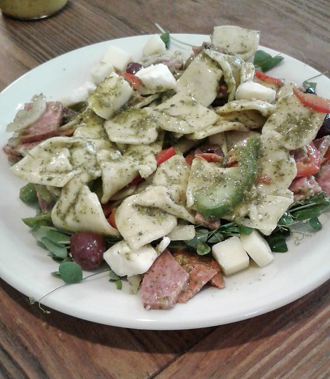 The antipasto salad arrives like an edible mosaic – meats, cheeses, and vegetables arranged with the care of an artist's final brushstrokes.