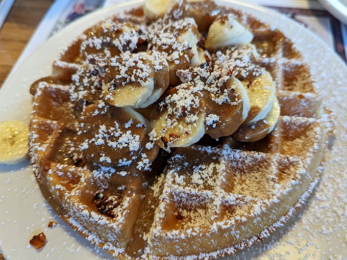 Waffle perfection isn't just about the grid marks – it's about those bananas, that dusting of cinnamon, and the way maple syrup pools in every square.