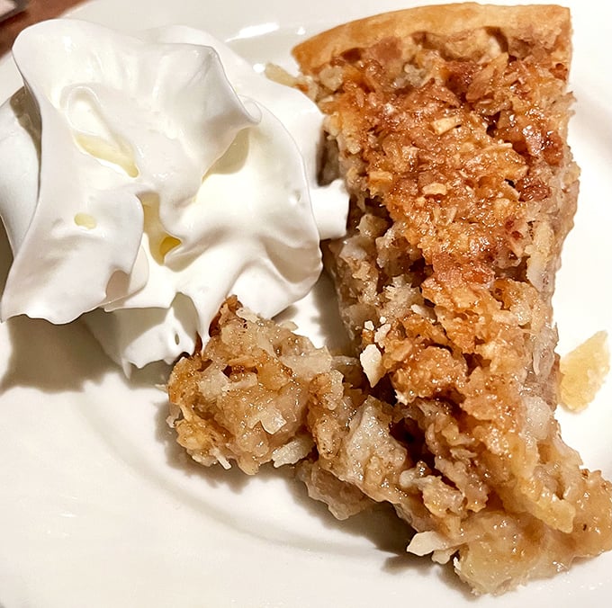 Apple pie with a cloud of whipped cream—the dessert equivalent of a warm hug from your favorite grandparent. Simple perfection on a plate.
