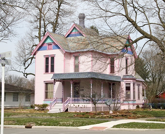 This cotton-candy pink Victorian house looks like it was plucked straight from a storybook, complete with gingerbread trim and wraparound porch.