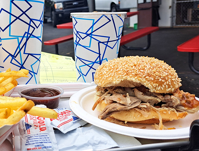 BBQ sandwich artistry on display: tender pulled meat piled high on a toasted bun. The kind of sandwich that demands both napkins and respect.