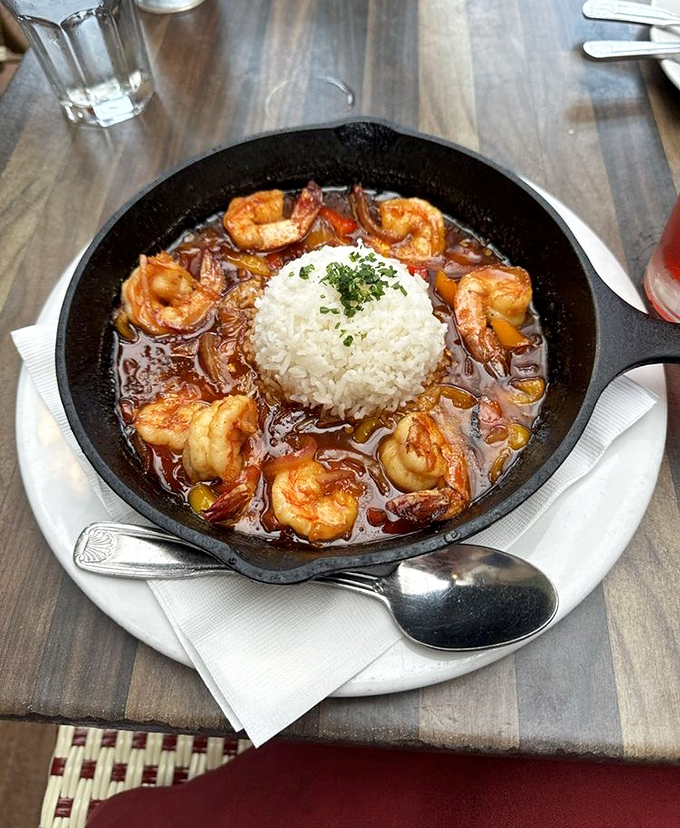 BBQ shrimp served in a cast iron skillet—because when food arrives still sizzling, you know you're in for a flavor concert.