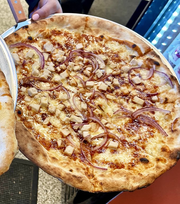 BBQ chicken pizza with those perfect red onion rings—proof that Italy and American BBQ can have a delicious love child.