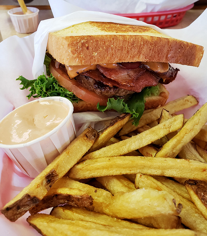 This isn't just a sandwich—it's architecture. Layers of flavor stacked between Texas toast with crispy fries standing guard.