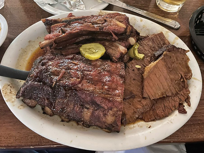 Behold the brisket and ribs platter—a meat mosaic that would make a Texan weep with joy. That bark has more character than most Hollywood scripts.