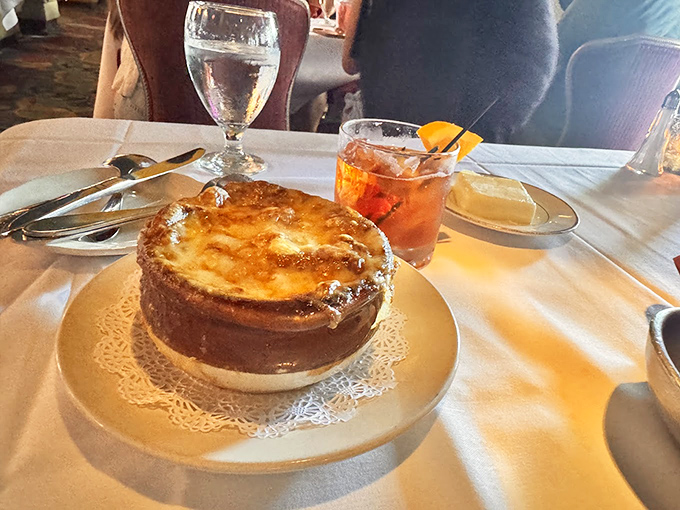 French onion soup that's worth the cheese pull photo op—a bubbling cauldron of comfort topped with golden, crusty perfection.