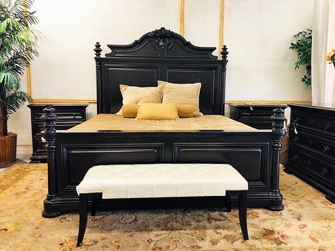 This stately black four-poster bed isn't just furniture—it's practically architectural, with details that whisper "old money" without saying a word.