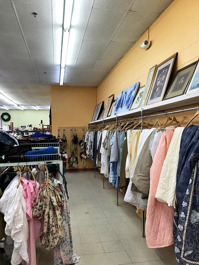 Clothing aisles organized by color create a rainbow of secondhand possibilities and fashion time travel.
