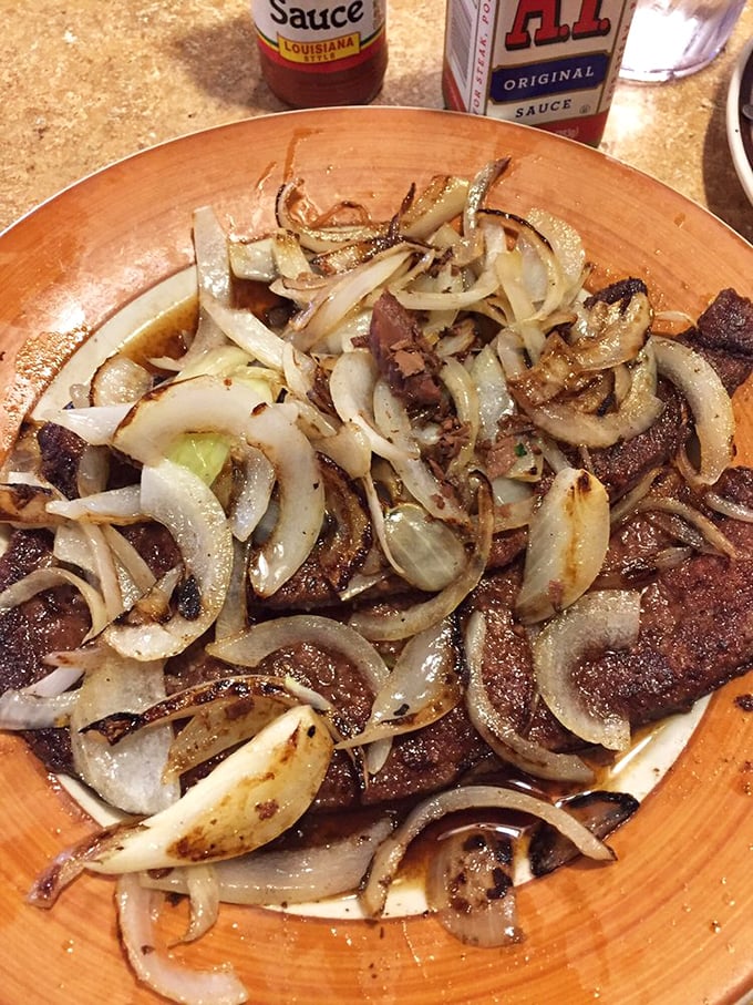 Caramelized onions dancing atop a perfectly seared steak—proof that simple ingredients in the right hands become extraordinary. This isn't just food; it's alchemy.