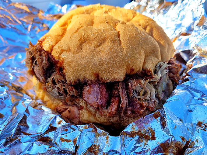 This isn't just a sandwich—it's an architectural marvel of smoke-ringed brisket that somehow manages to be both substantial and delicate.