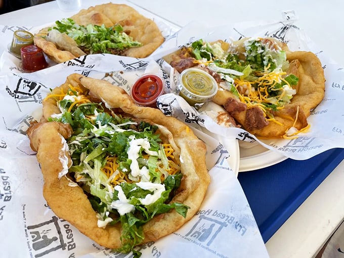 A trio of tacos that puts the "art" in "culinary artform" – each one a masterpiece of texture and flavor on pillowy fry bread.