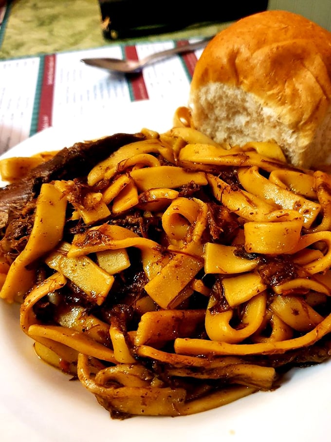 Beef and noodles that redefine comfort food—wide, tender pasta ribbons swimming alongside slow-cooked meat in a gravy worth bottling and taking home.