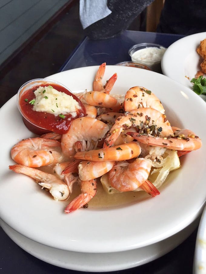 Plump shrimp that practically snap with freshness, arranged like they're posing for their seafood yearbook photo. That cocktail sauce isn't just a condiment—it's a statement.