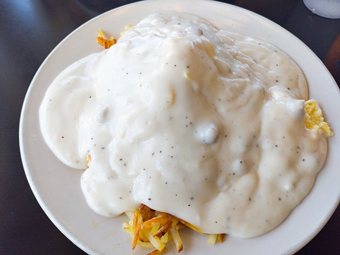 The biscuits and gravy here don't just smother—they embrace. A peppery white blanket tucking in those fluffy biscuits for the nap they'll never take.