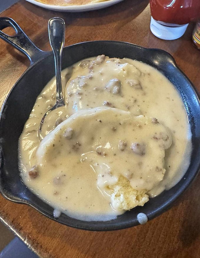 This isn't just biscuits and gravy—it's a cast iron skillet of Southern salvation, with cream gravy thick enough to stand a spoon in.