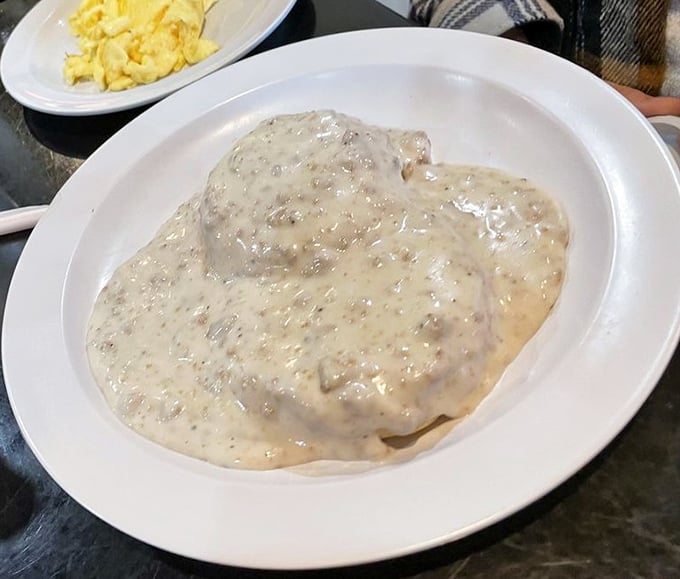 Biscuits and gravy so creamy they should require a permission slip. This plate doesn't whisper "comfort food"—it belts it out like Aretha Franklin.
