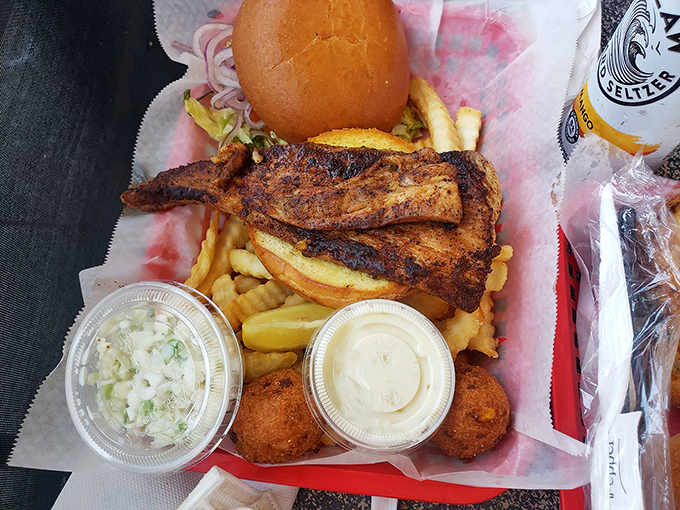 This blackened fish sandwich isn't just lunch—it's a coastal ritual. The fries and hush puppies are merely supporting actors in this seafood drama.