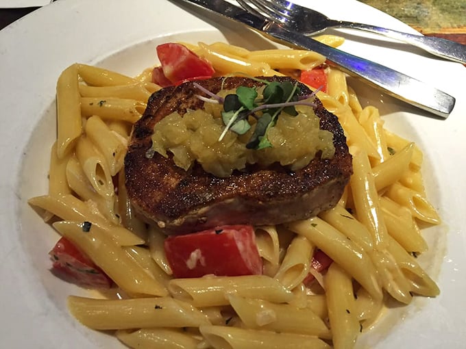 Blackened tuna perched atop pasta like a culinary crown jewel. The sauce whispers "fancy" while the pasta says "comfort"—the best of both worlds.