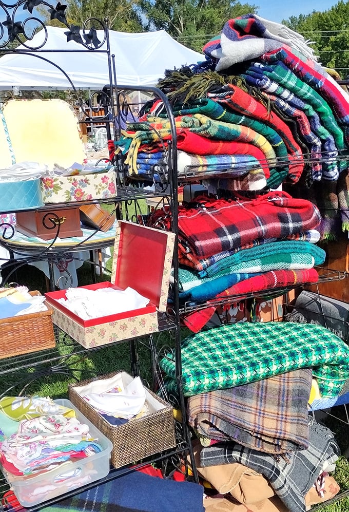 Wool blankets in every pattern imaginable create a textile library. These aren't just blankets—they're portable time machines to grandma's living room.