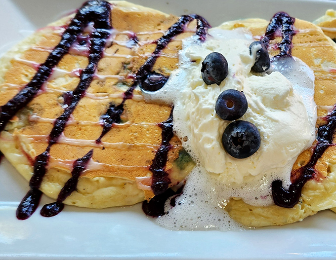 Pancakes that make you question every other pancake you've ever eaten. That blueberry drizzle isn't just photogenic—it's the breakfast equivalent of a perfect sunset.