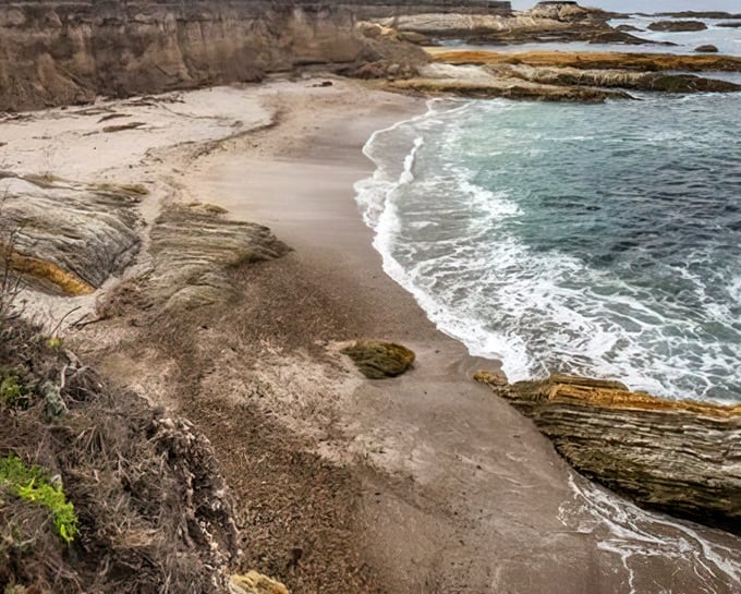 This hidden cove looks like it was borrowed from a pirate movie set. Half expect to find buried treasure beneath those golden sands.