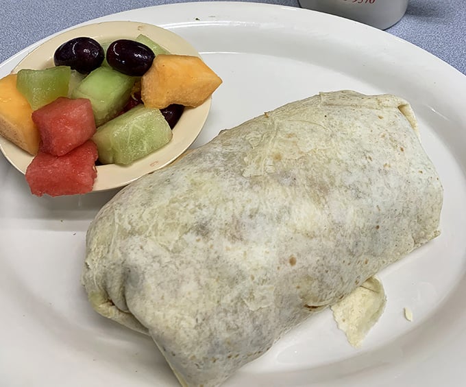 Breakfast goes portable with this burrito that's stuffed fuller than your suitcase before a weekend getaway, with fresh fruit providing color commentary.